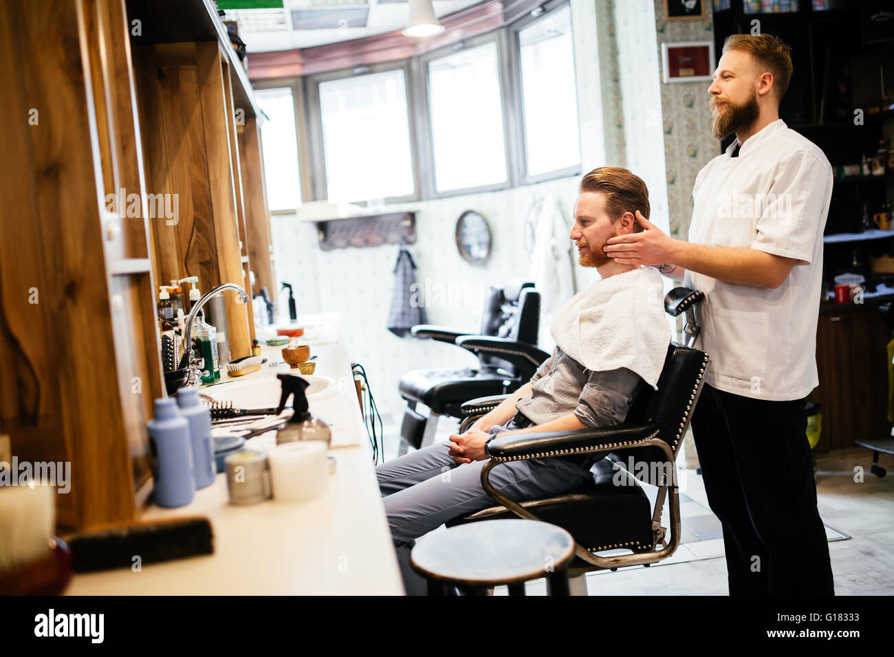 Male receiving hair beard treatment in barber shop Stock Photo - Alamy
