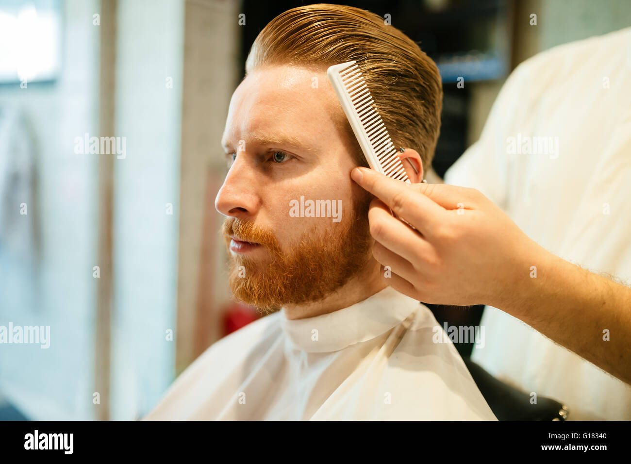 Combing of hair and styling in barber shop Stock Photo - Alamy