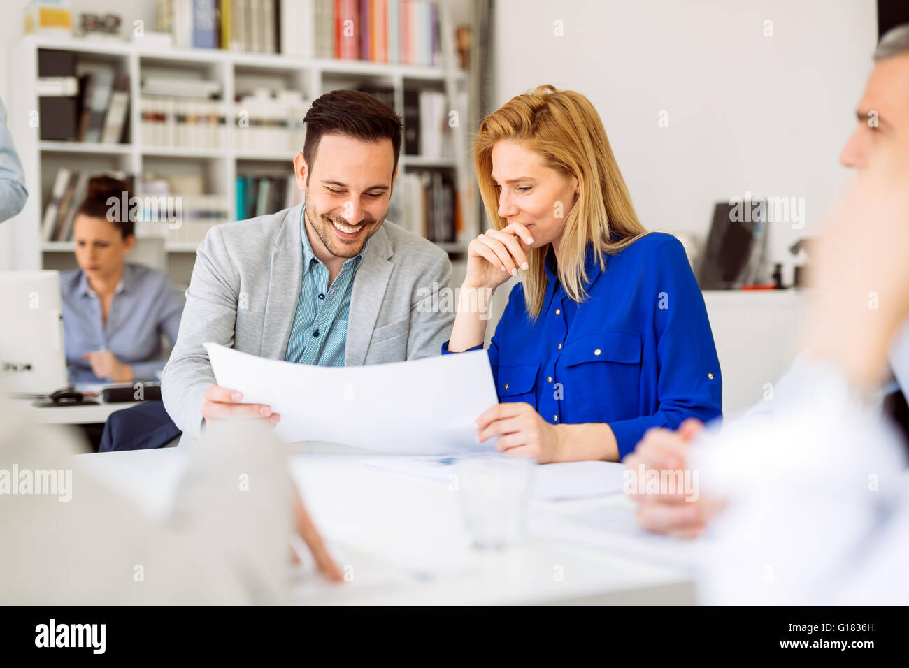 Successful business partners brainstorming in office Stock Photo - Alamy