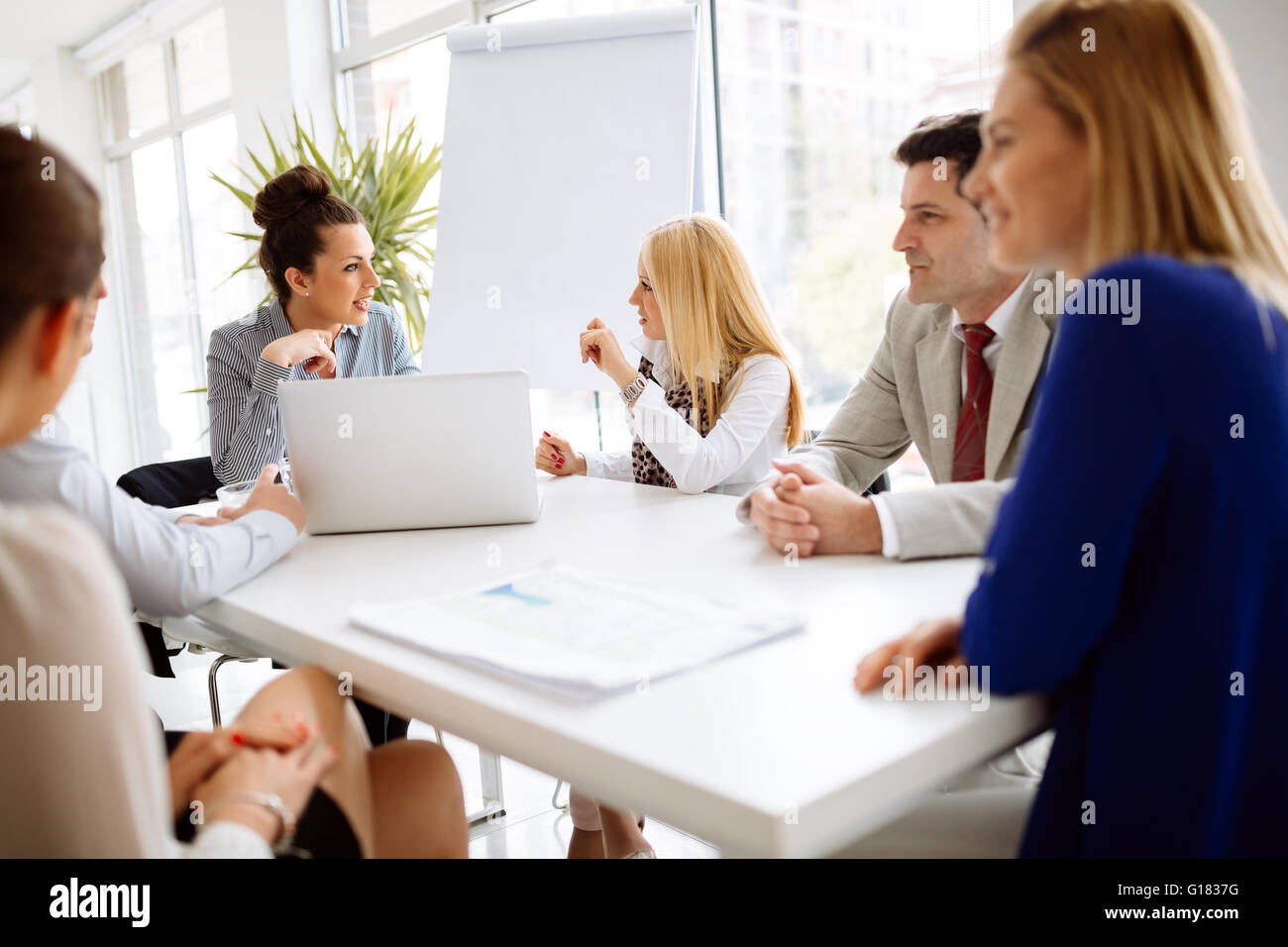 Successful business partners brainstorming in office Stock Photo - Alamy