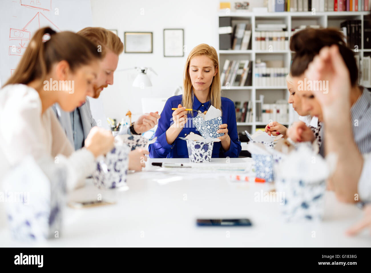 Colleagues eating in office during lunch break Stock Photo - Alamy