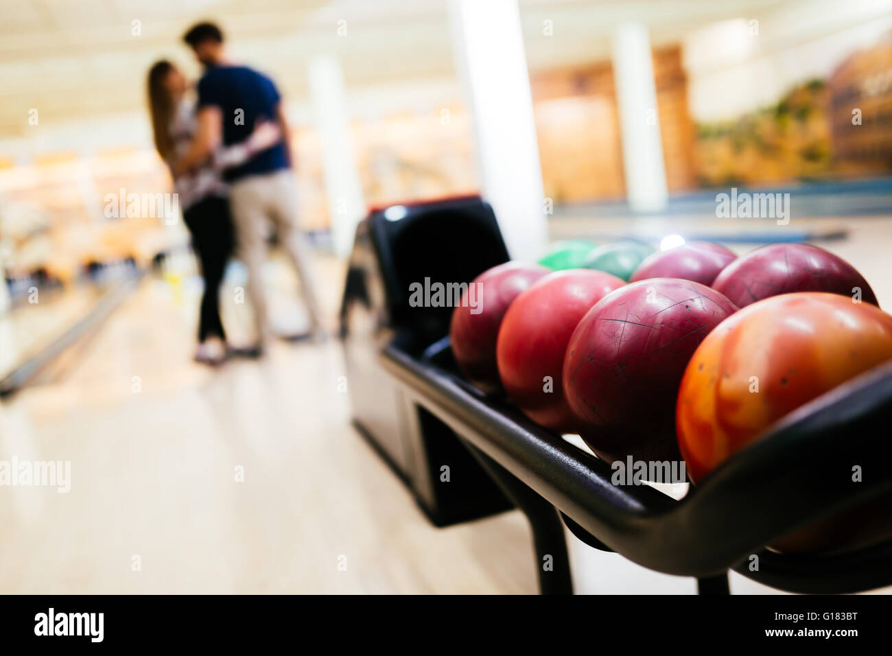Couple enjoy bowling together and hugging Stock Photo - Alamy