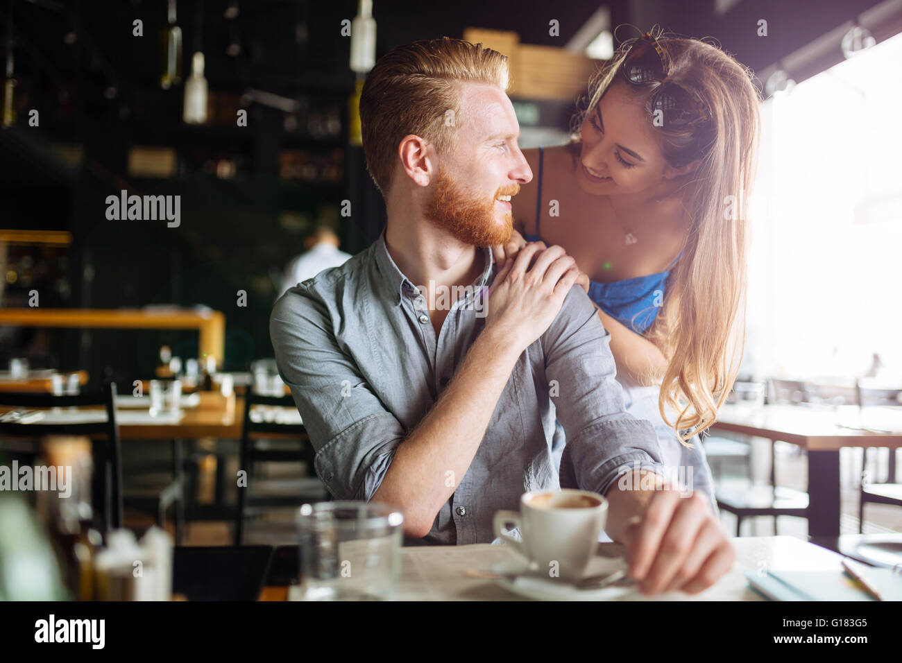 Beautiful man and woman flirt in cafe Stock Photo - Alamy
