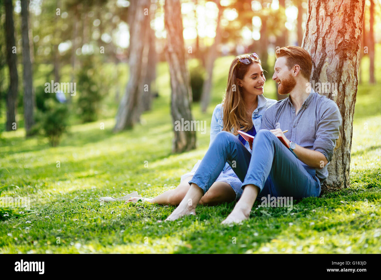 Beautiful couple studying together for exams in nature Stock Photo - Alamy