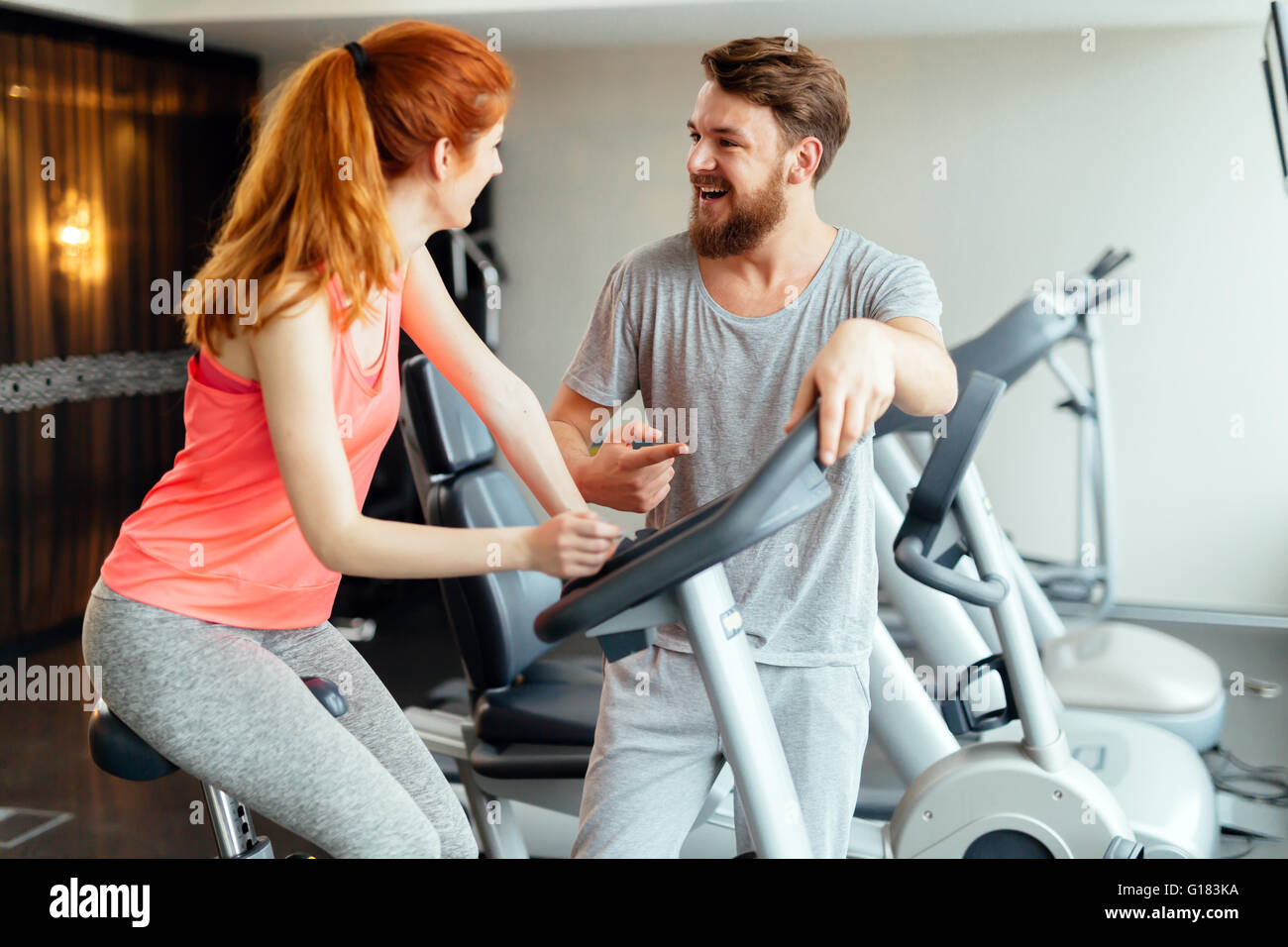 Personal trainer giving instructions in gym Stock Photo - Alamy