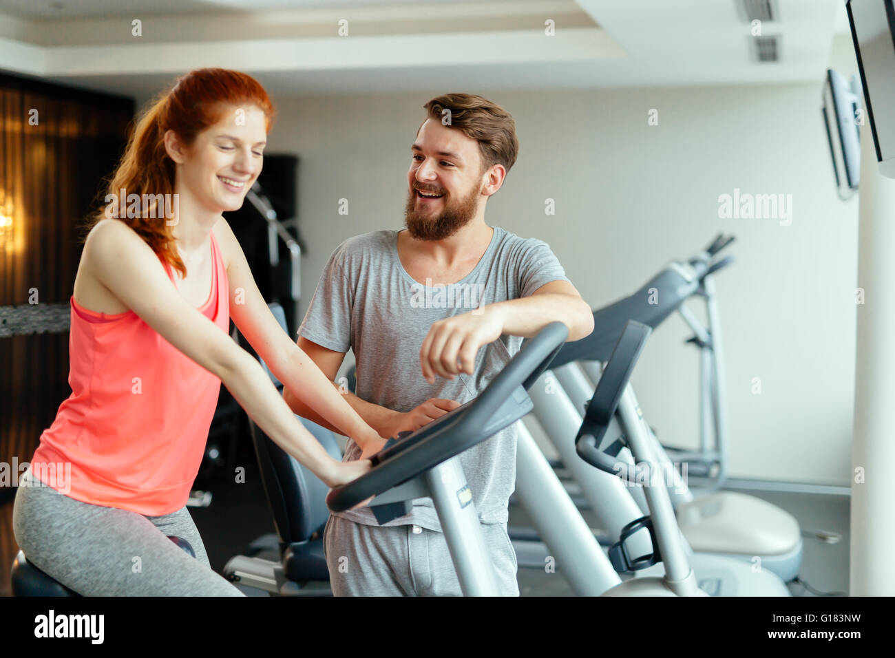 Personal trainer giving instructions in gym Stock Photo - Alamy
