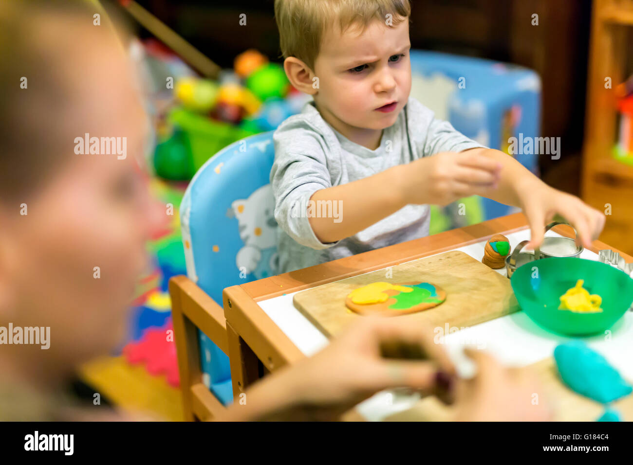 Little boy being creative with playdough Stock Photo - Alamy