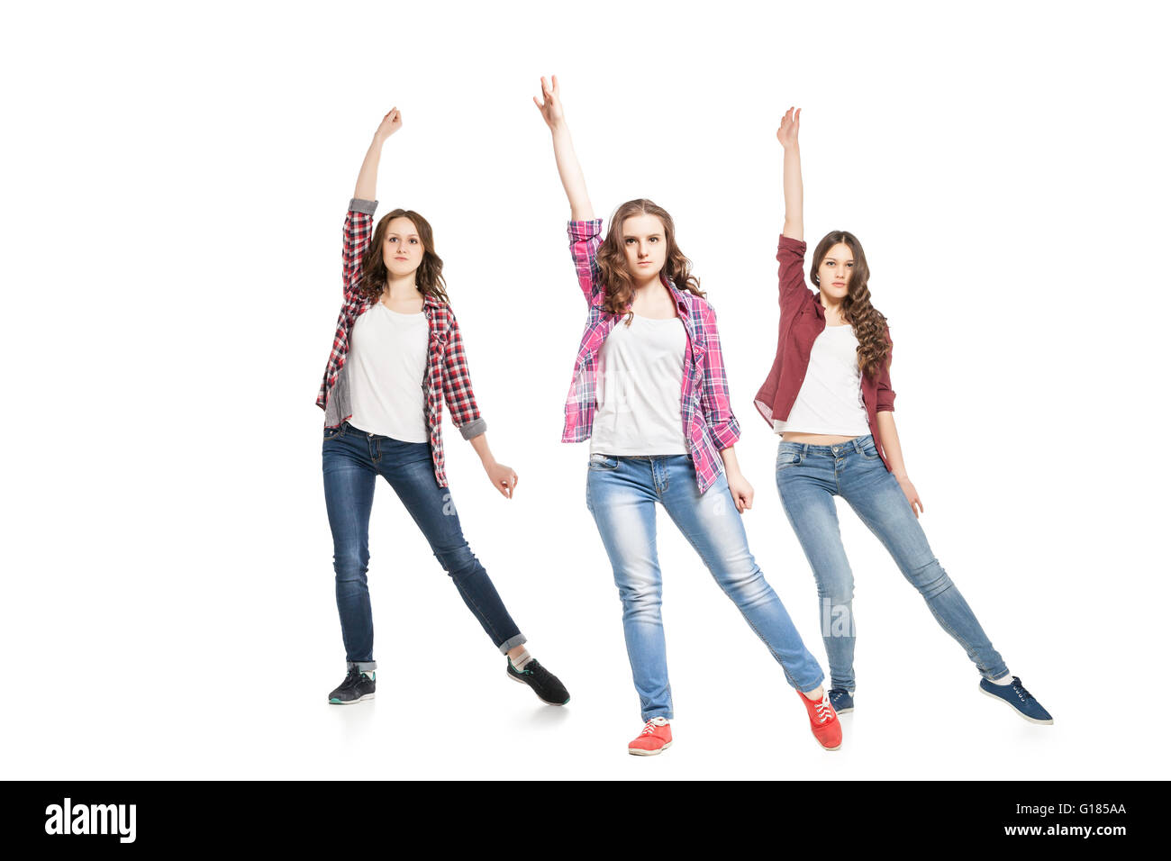 three young women dancing over white background Stock Photo - Alamy