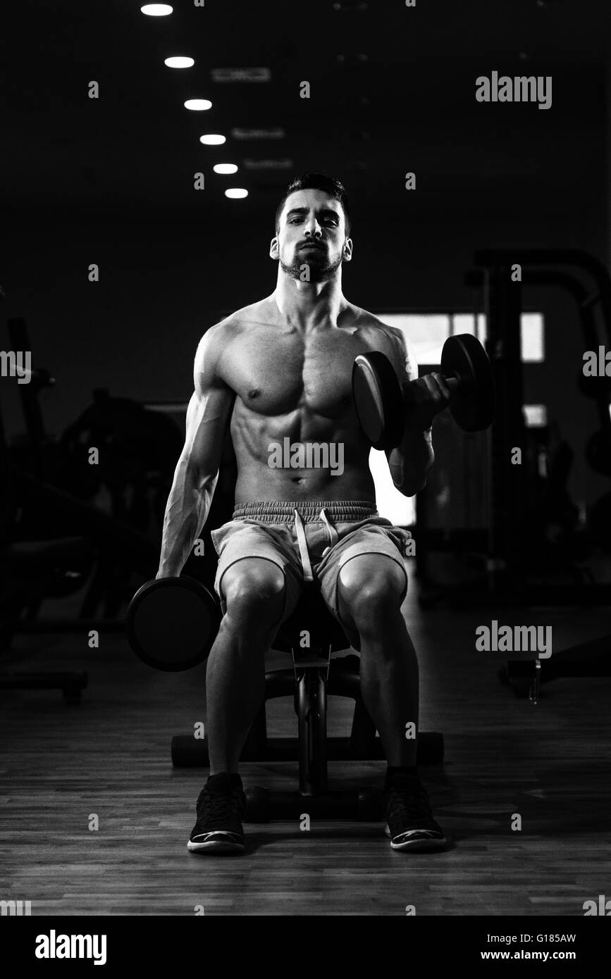 Muscular man dumbbells exercises Black and White Stock Photos & Images ...