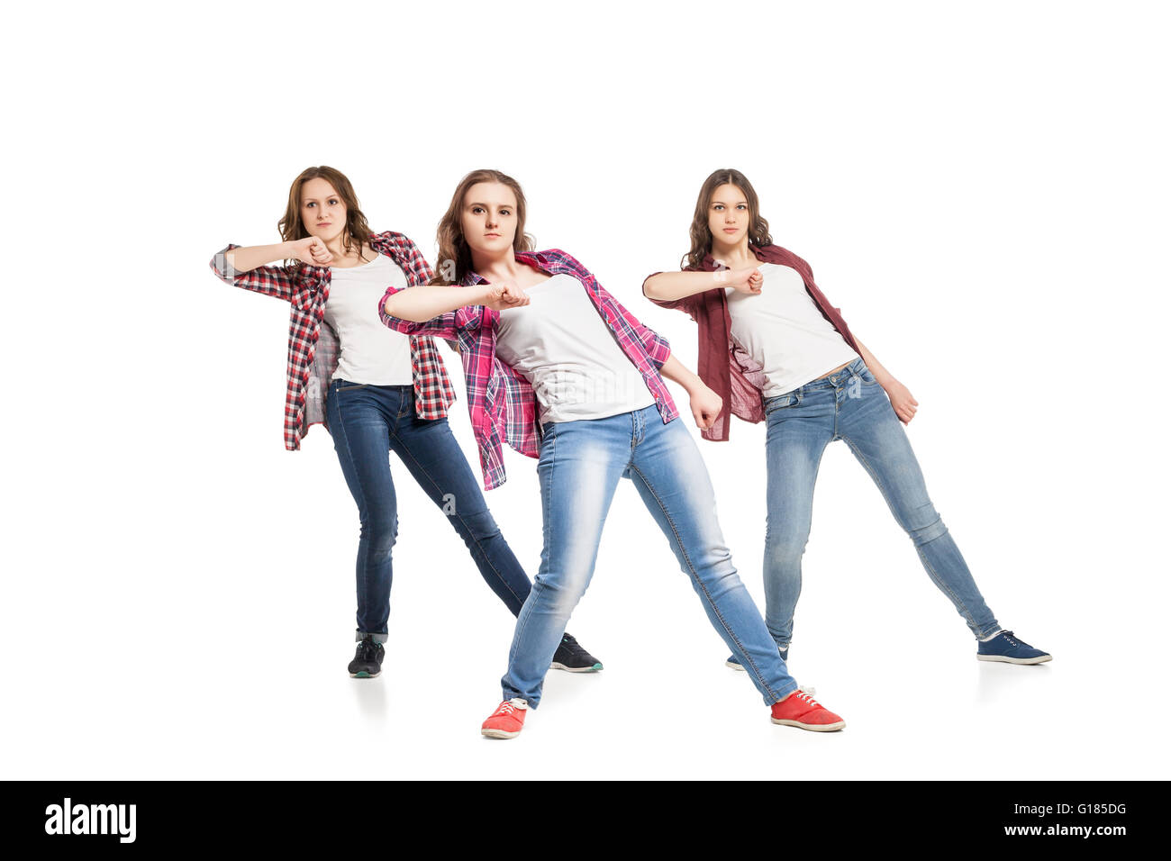 three young women dancing over white background Stock Photo - Alamy