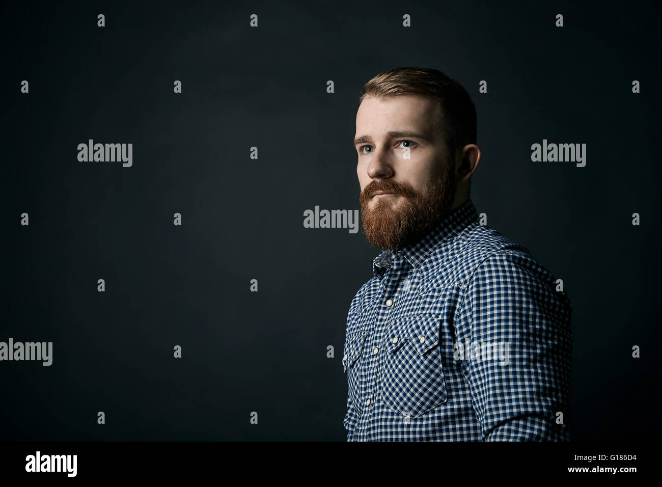 Red bearded man studio portrait on dark background Stock Photo - Alamy
