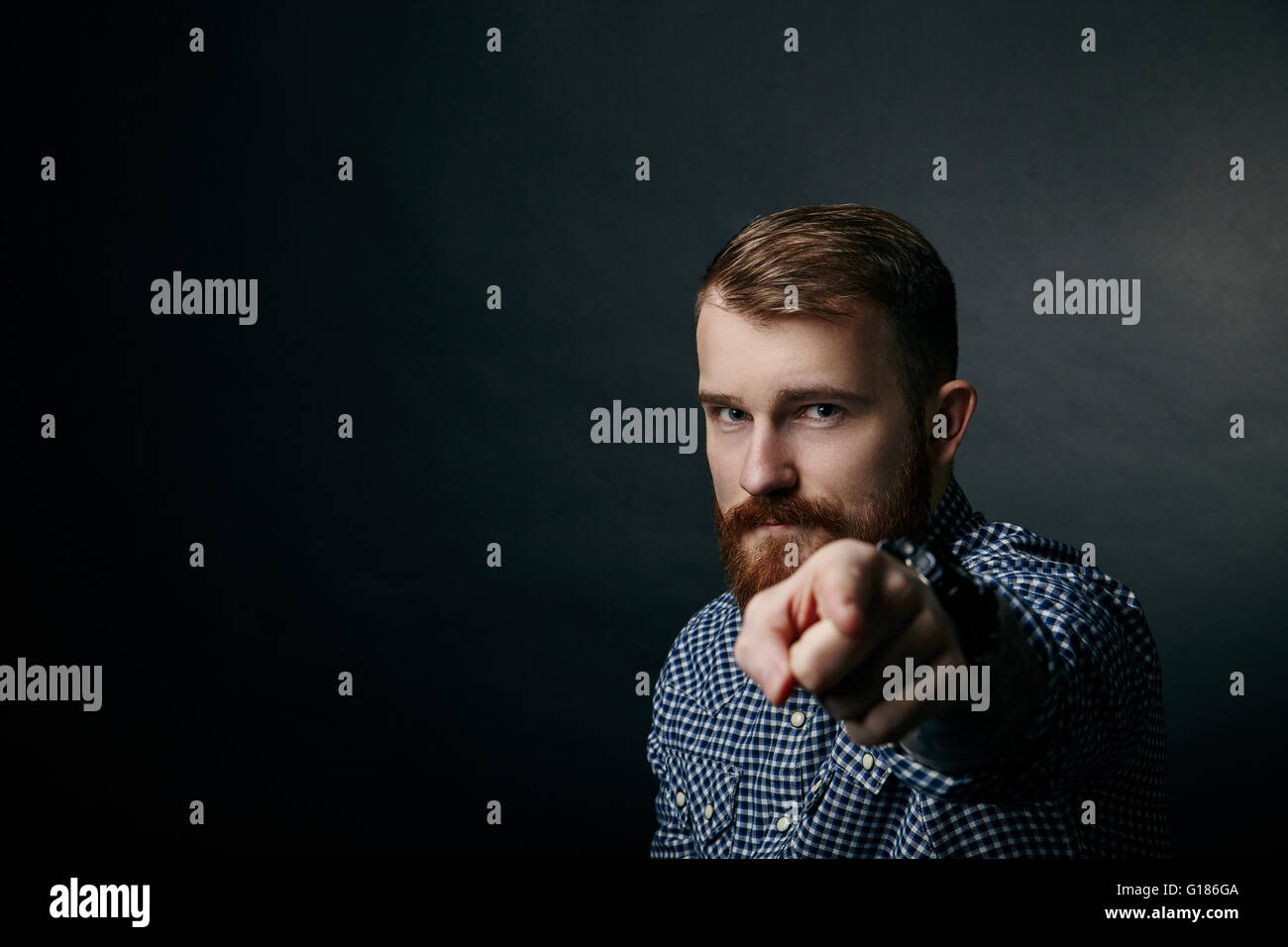 Red bearded man pointing studio portrait on dark background Stock Photo ...