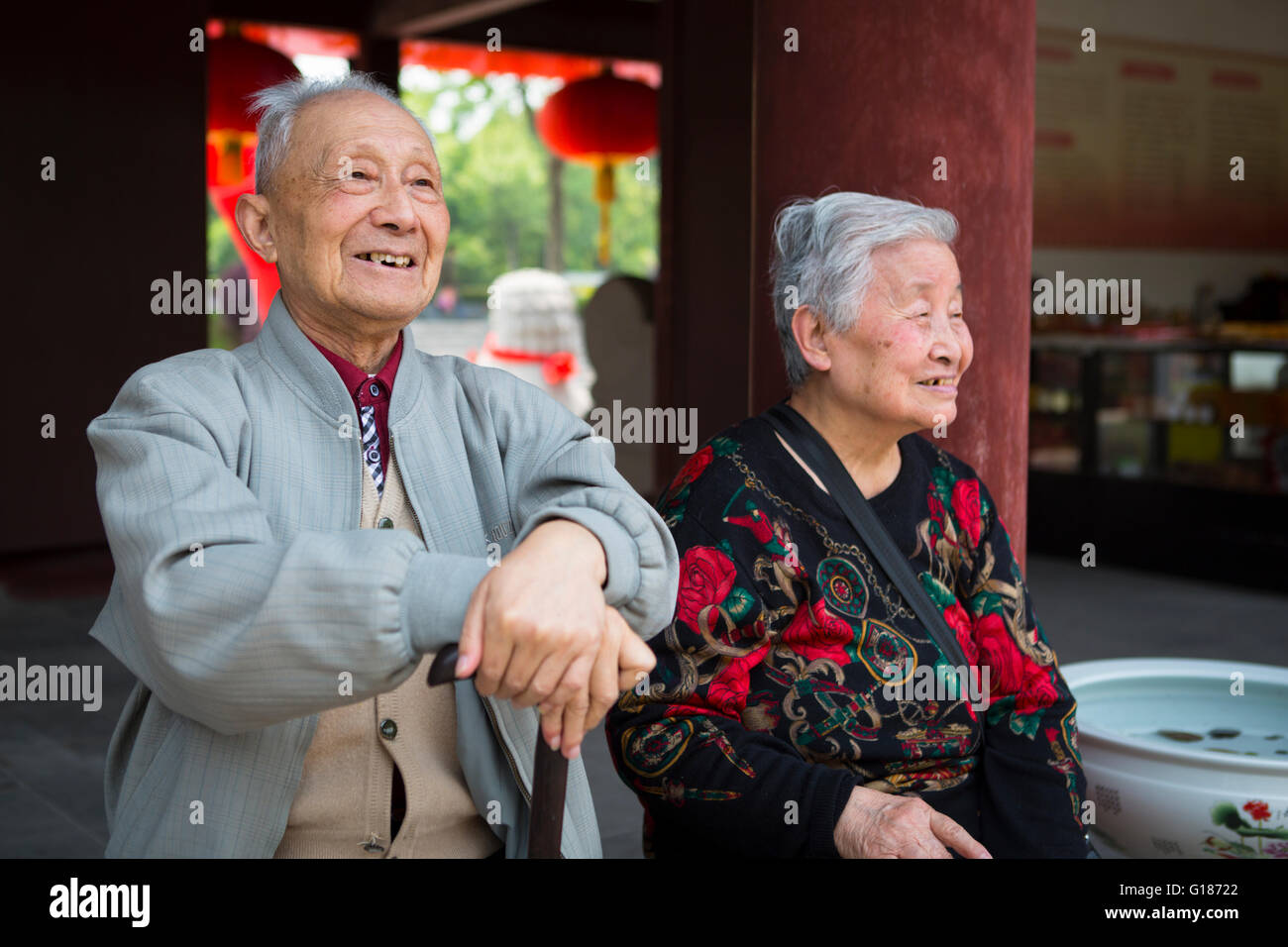 Smiling senior Chinese married couple relaxing in a Buddhist temple in ...