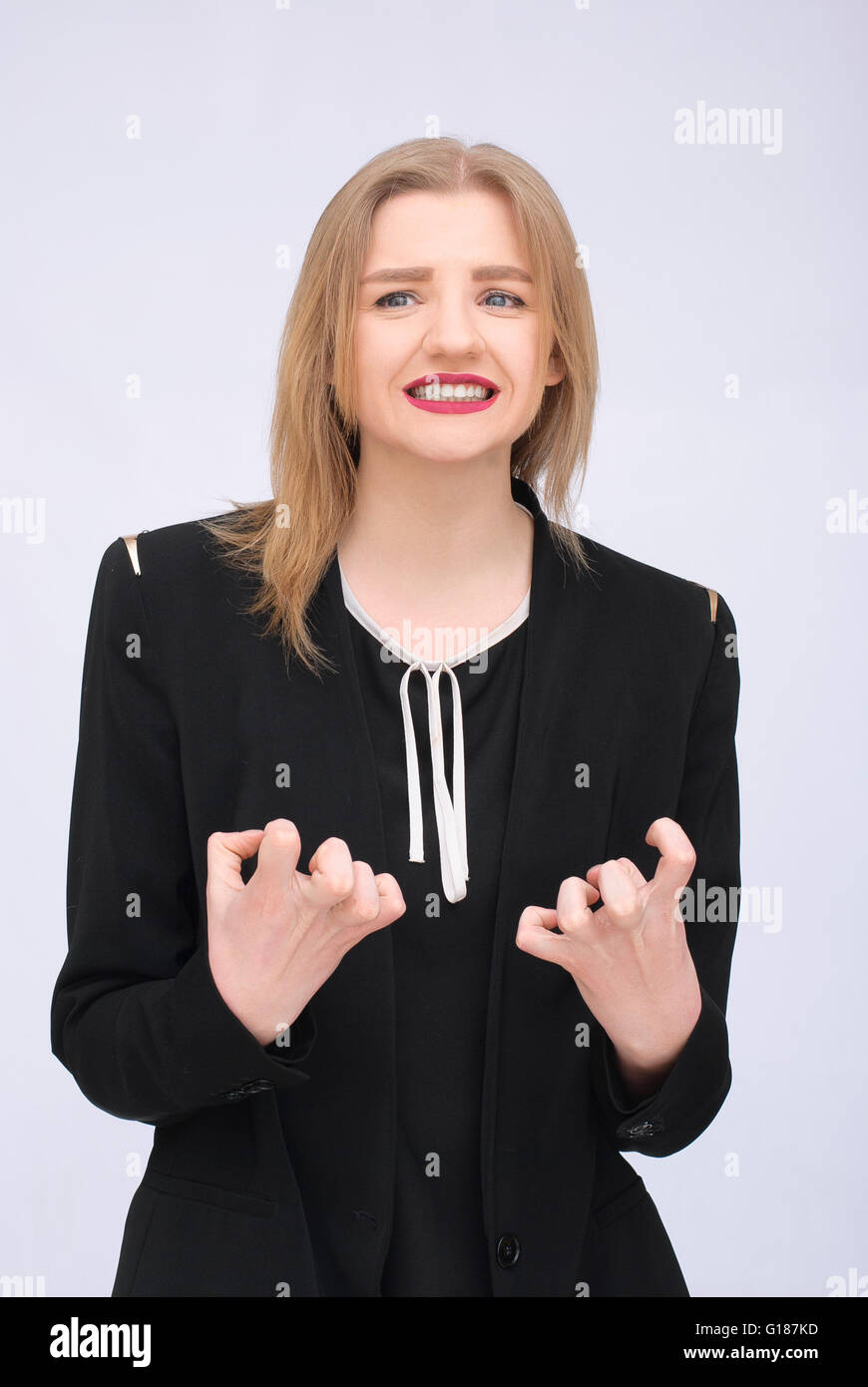 Angry businesswoman in black suit Stock Photo - Alamy