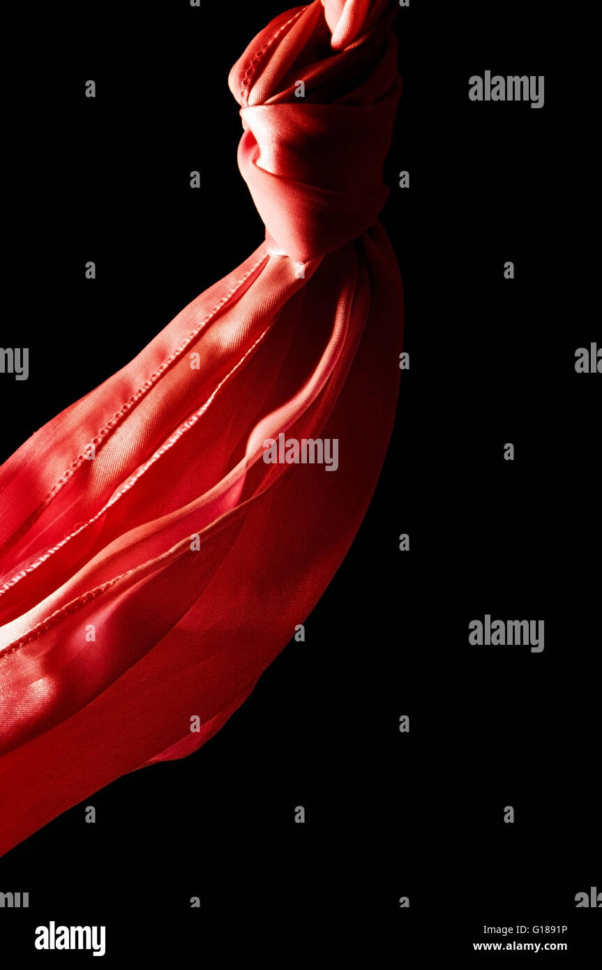 red silk scarf over back background Stock Photo - Alamy