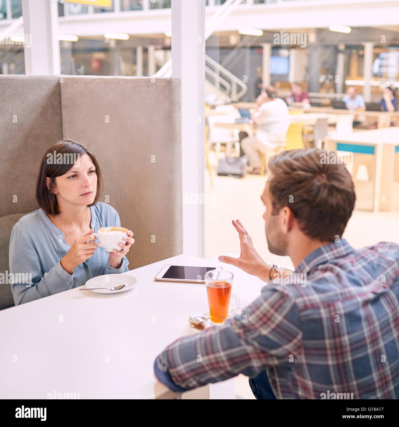 Woman looks angrily at her boyfriend as he tries to explain why it is ...