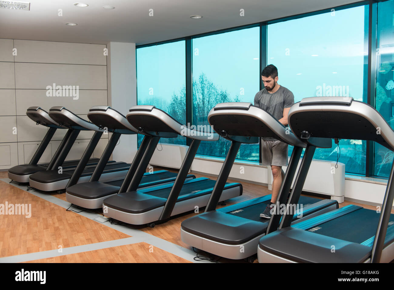 Handsome Man Running On The Treadmill In Gym Stock Photo - Alamy