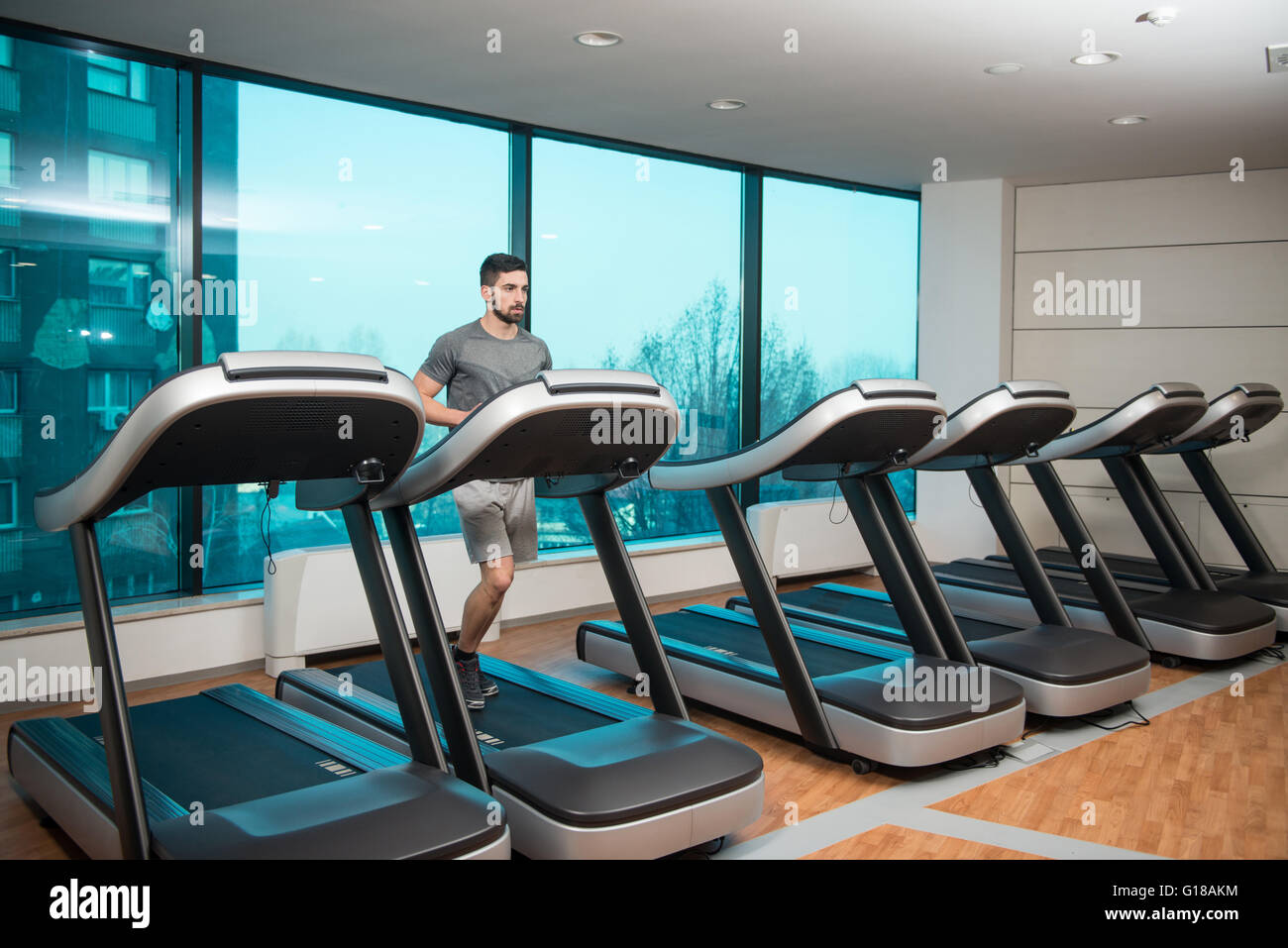 Handsome Man Running On The Treadmill In Gym Stock Photo - Alamy