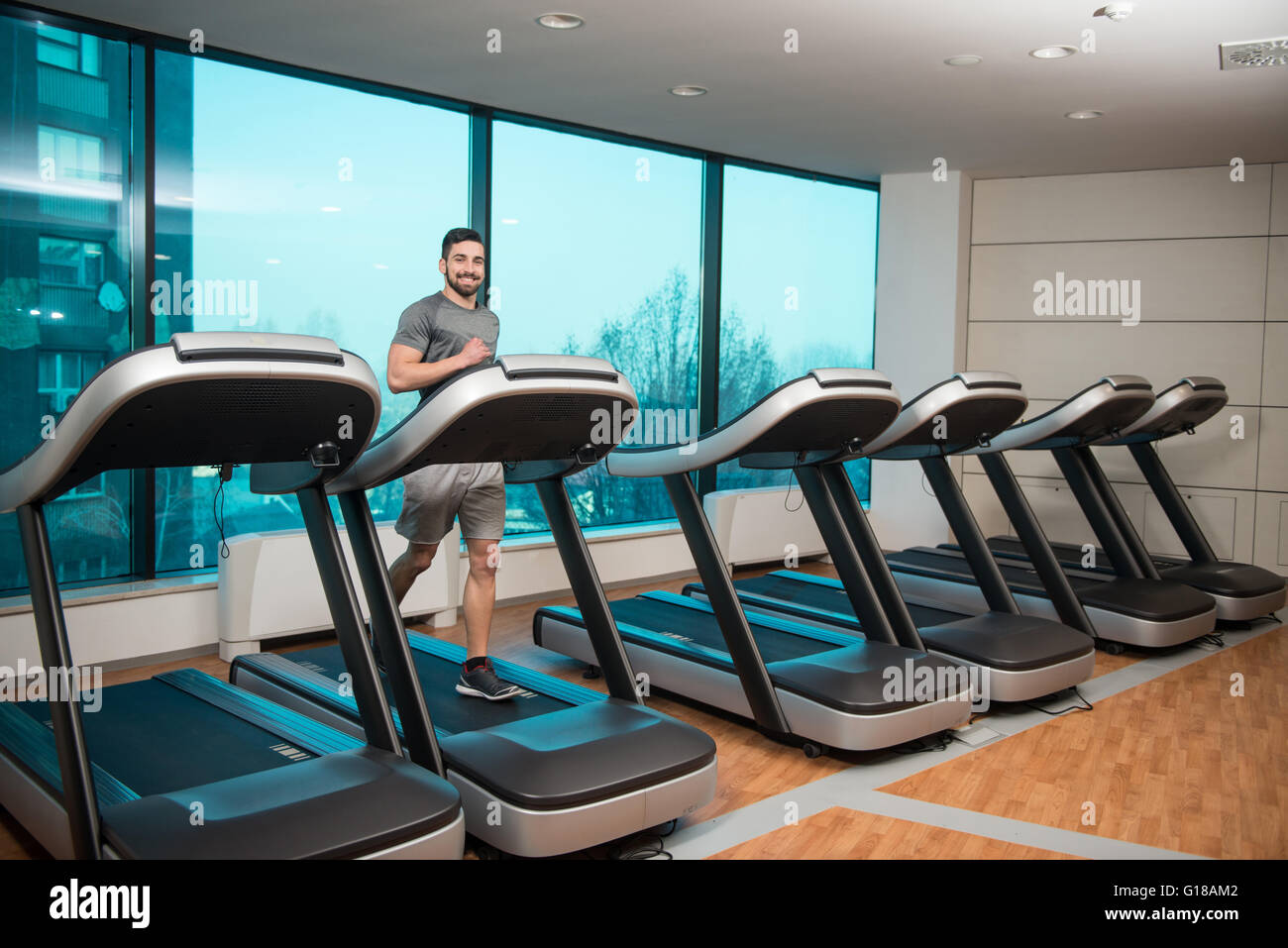 Handsome Man Running On The Treadmill In Gym Stock Photo - Alamy