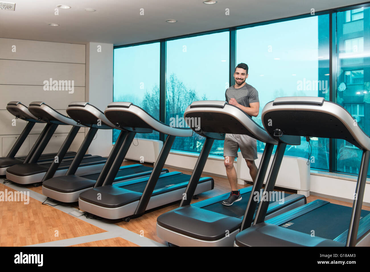 Handsome Man Running On The Treadmill In Gym Stock Photo - Alamy