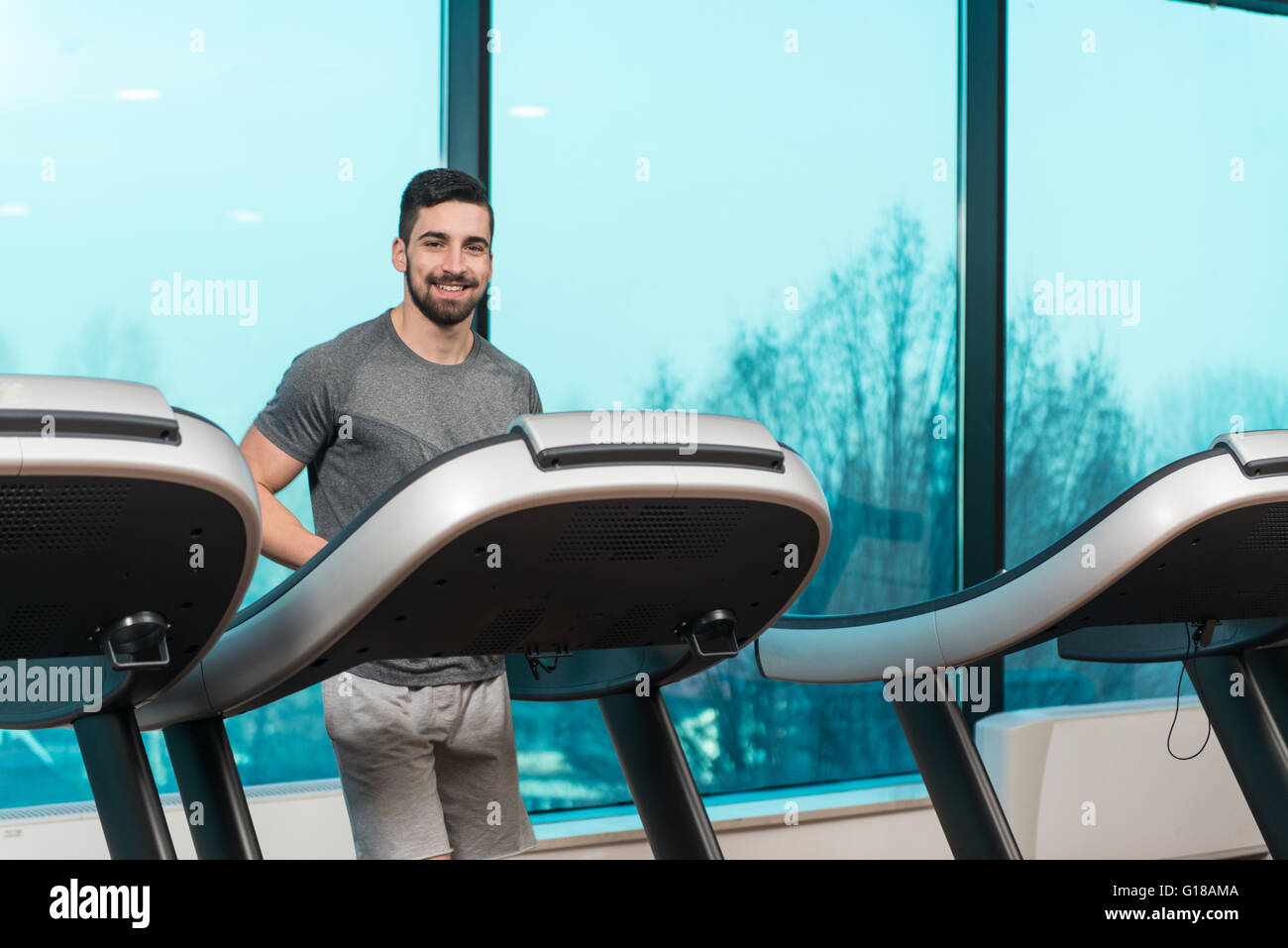 Handsome Man Running On The Treadmill In Gym Stock Photo - Alamy