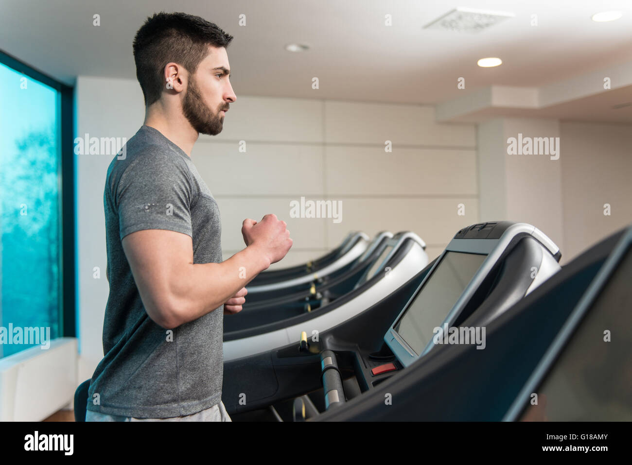 Handsome Man Running On The Treadmill In Gym Stock Photo - Alamy