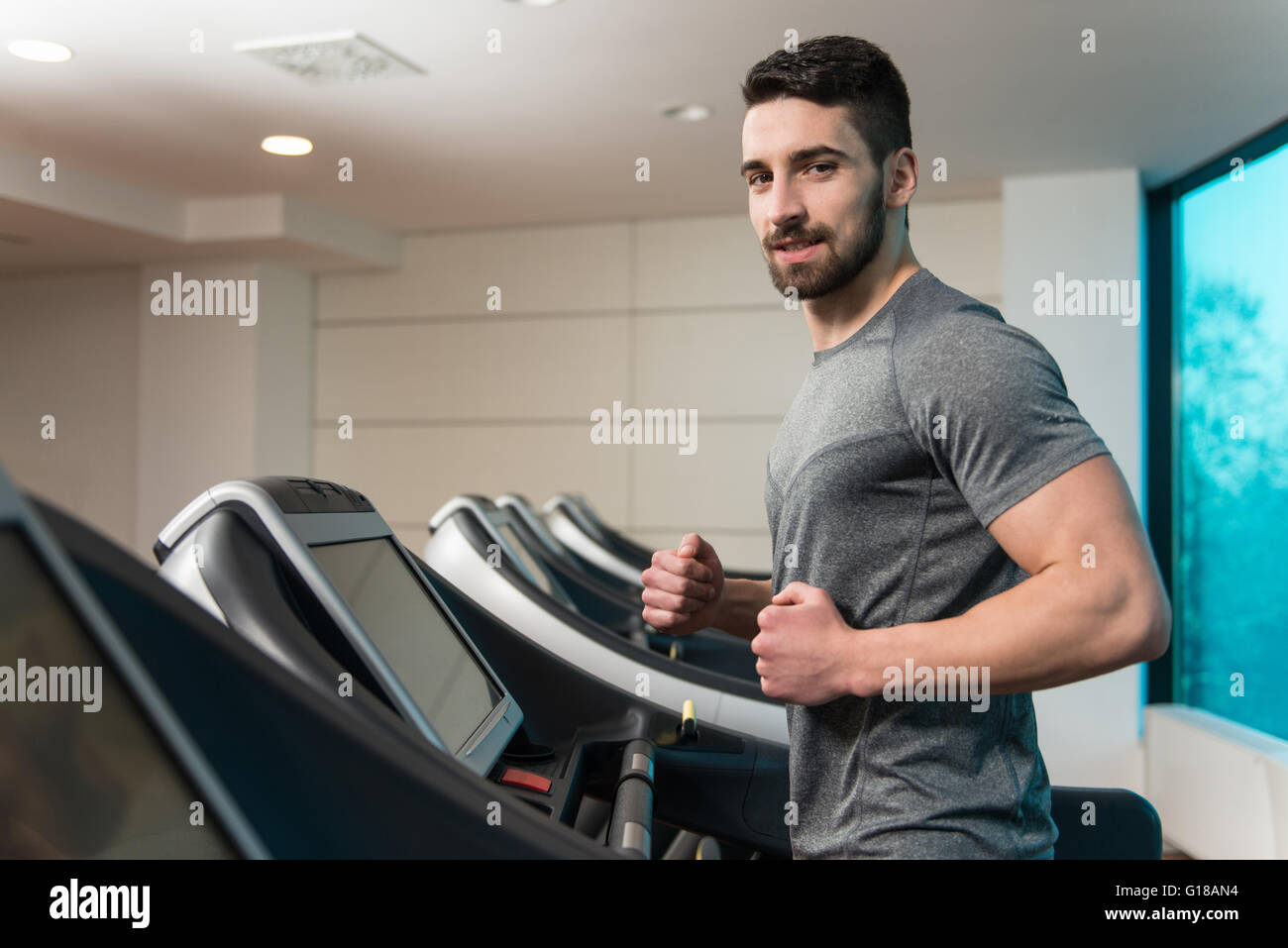 Handsome Man Running On The Treadmill In Gym Stock Photo - Alamy