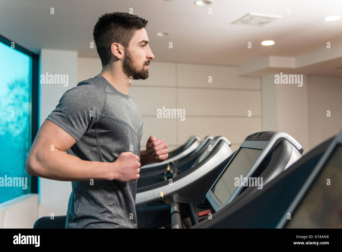 Handsome Man Running On The Treadmill In Gym Stock Photo - Alamy