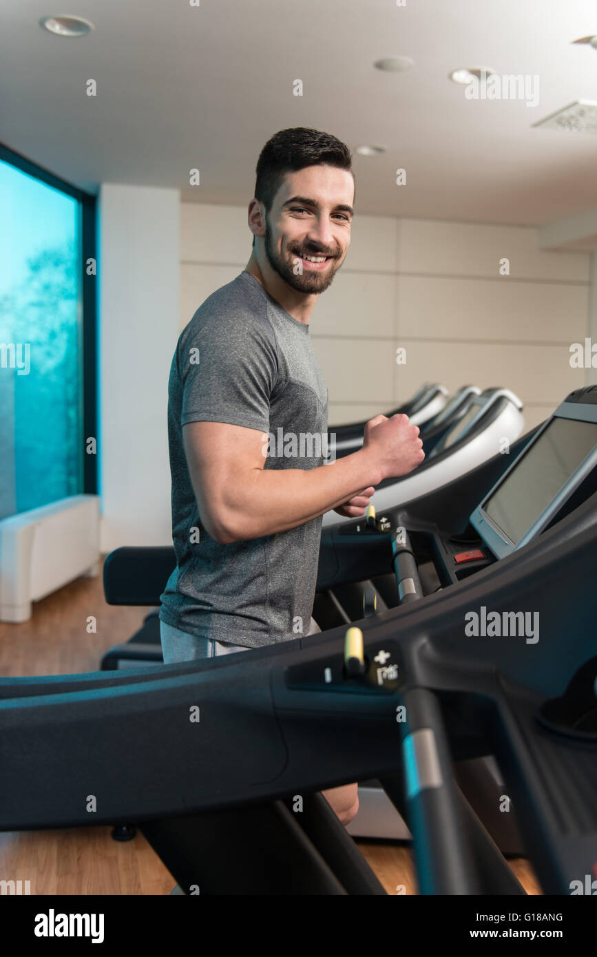 Handsome Man Running On The Treadmill In Gym Stock Photo - Alamy