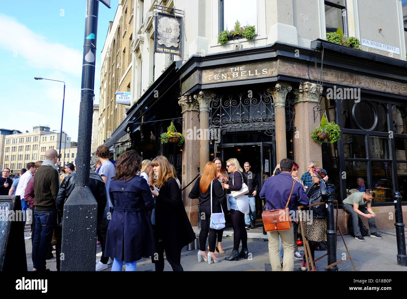 Crowd of people drinking outside The Ten Bells Pub in Shoreditch ...