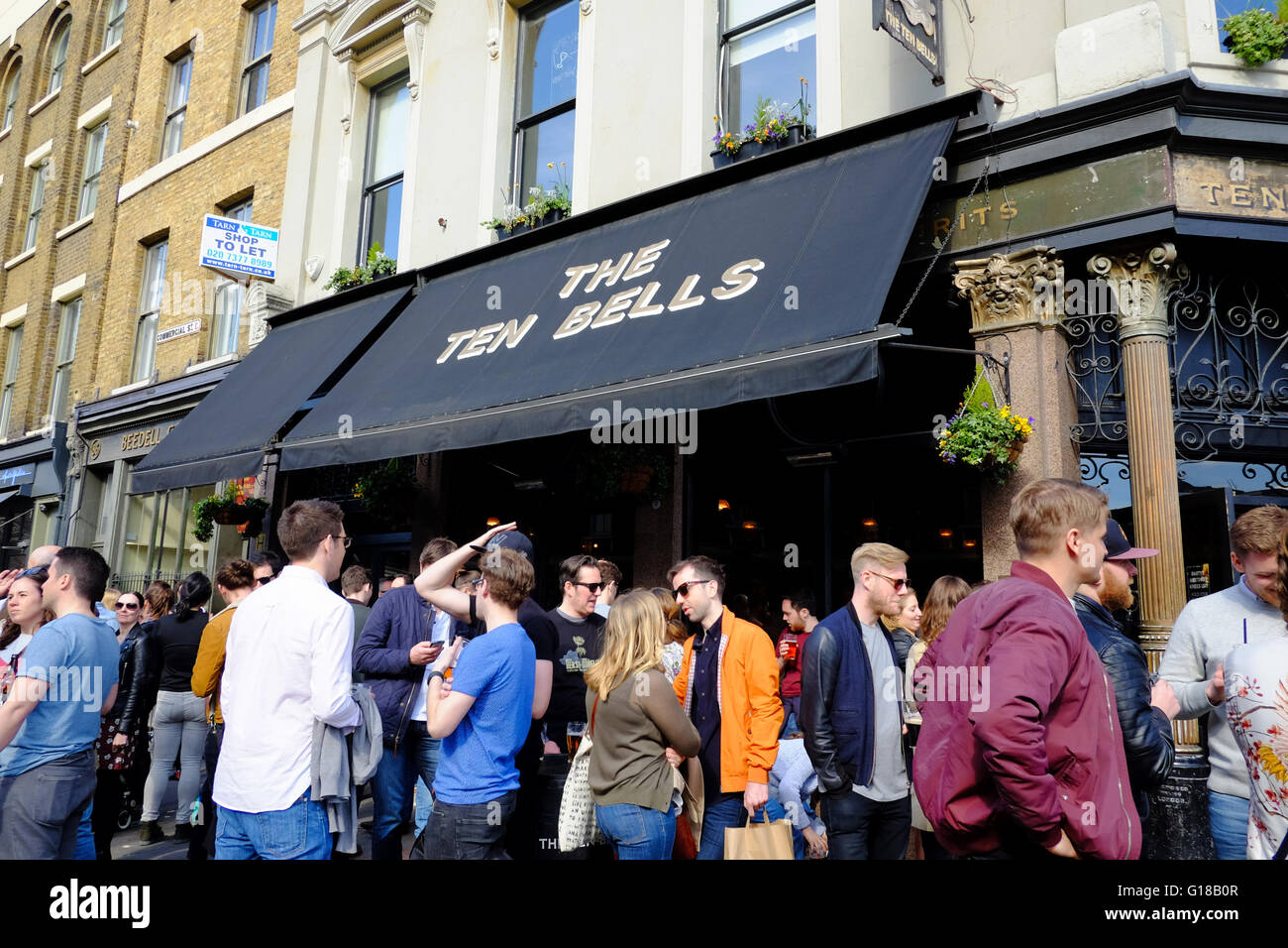 Crowd of people drinking outside The Ten Bells Pub in Shoreditch ...