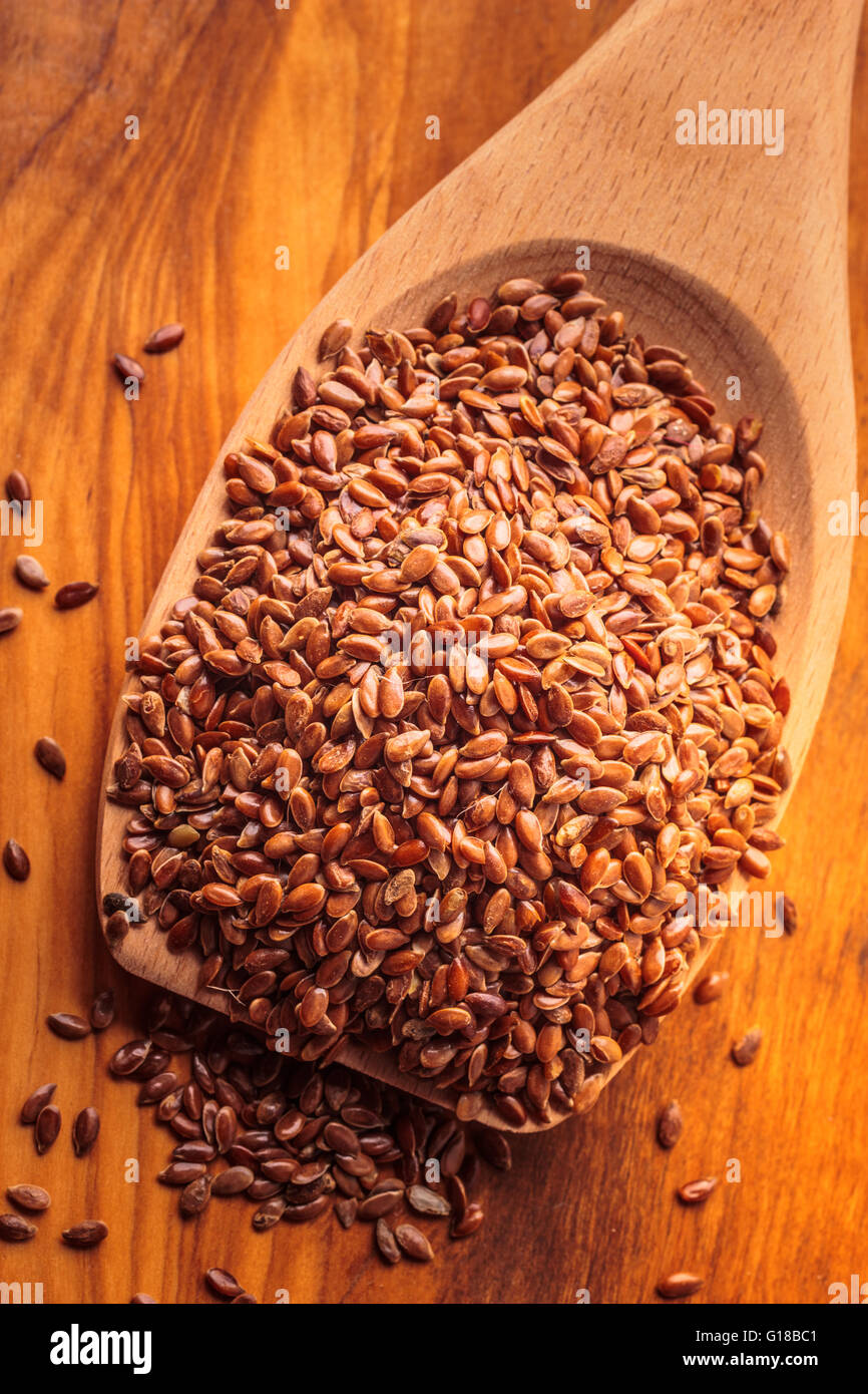 Healthy food for preventing heart diseases and overweight. Flax seeds linseed on wooden spoon ...