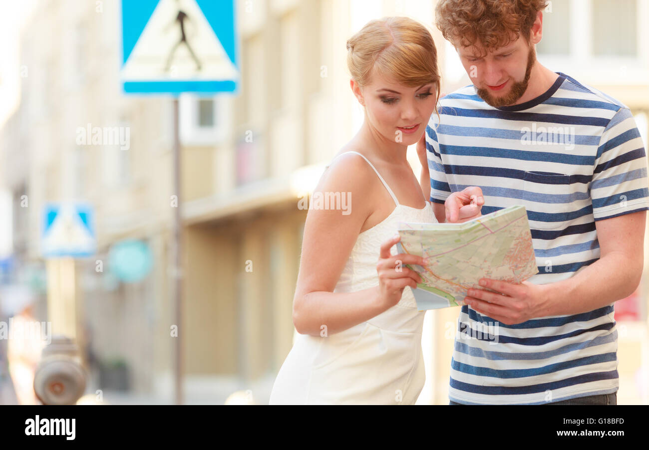 Summer travel concept. Young tourist couple on vacation city street ...