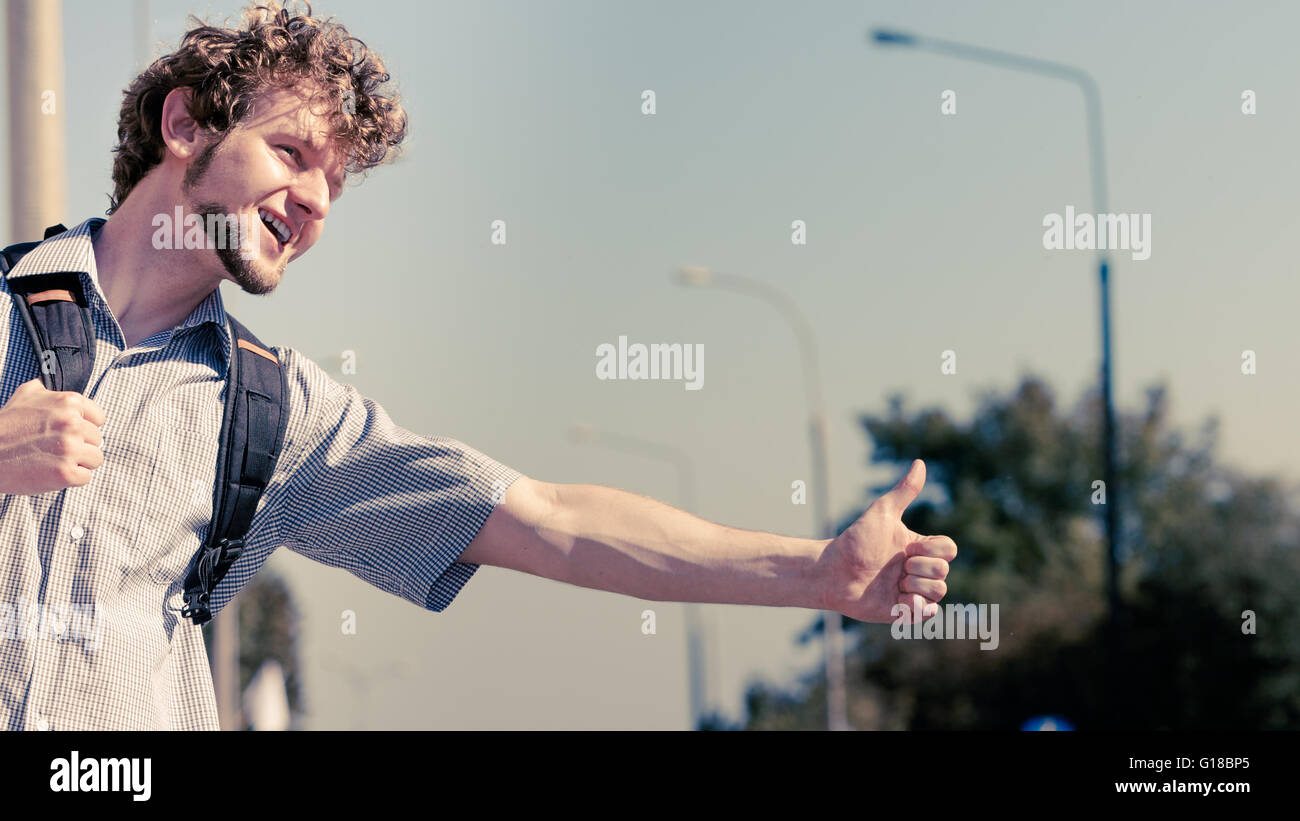 Young man hitchhiking on summer hi-res stock photography and images - Alamy
