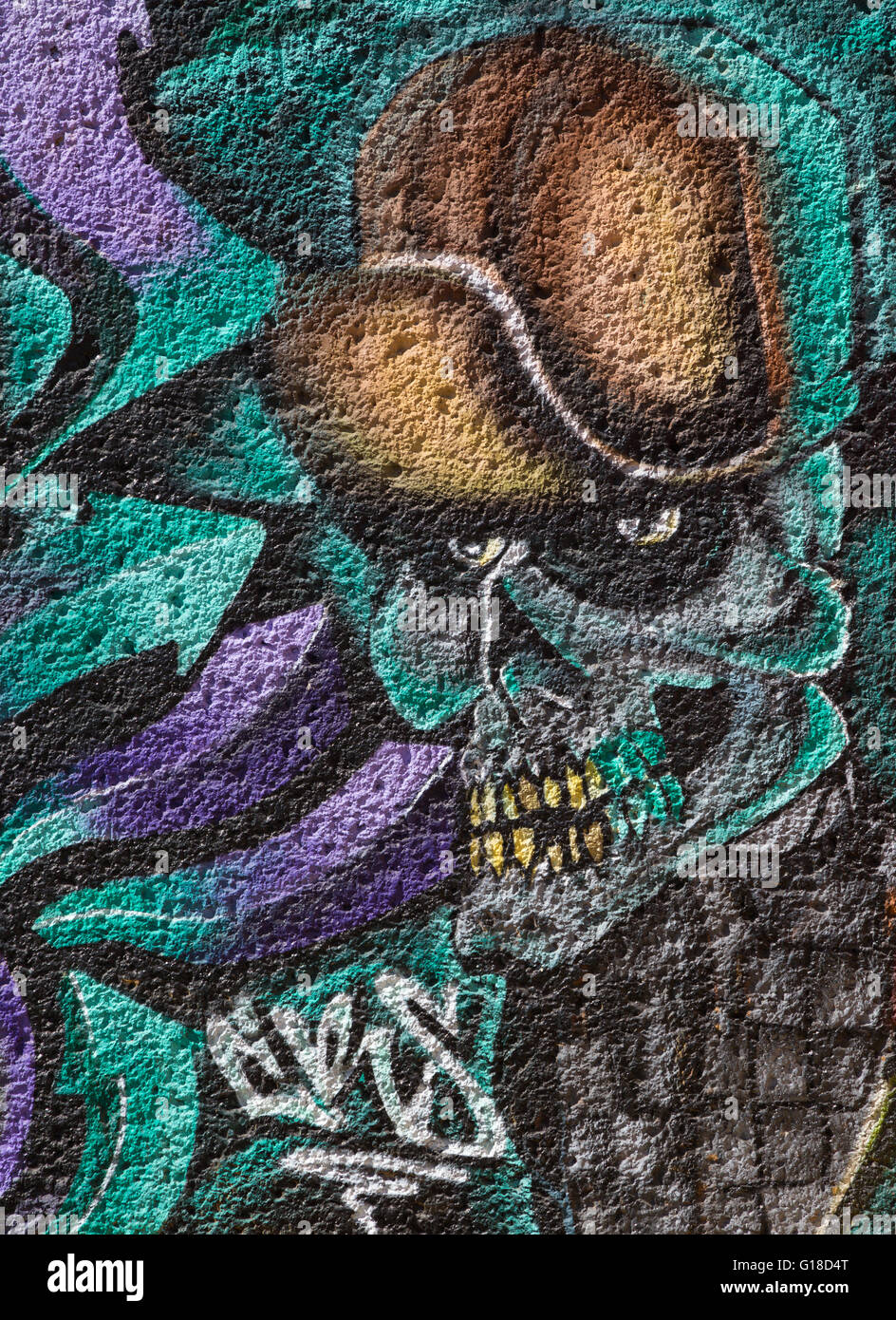 Urban art depicting skeleton wearing a hat in the Spanish colonial city ...