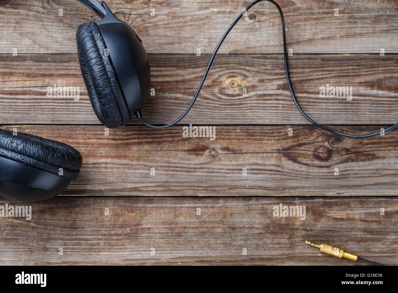 Headphones over wooden table Stock Photo - Alamy