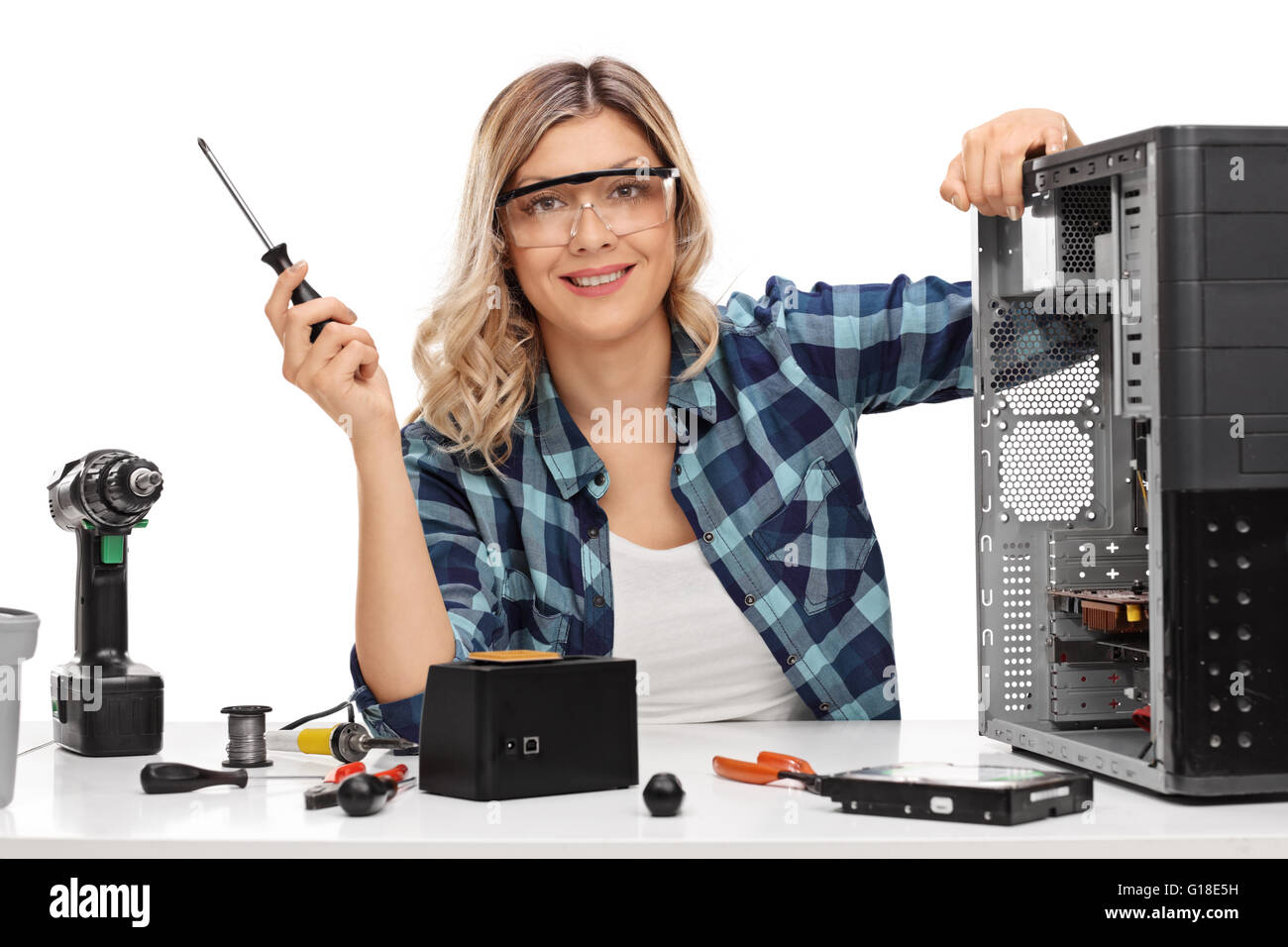 Female PC technician posing next to a disassembled desktop computer ...