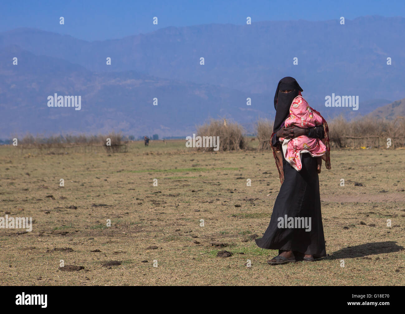 Ethiopian oromo mother with her baby dressed in burqa, Amhara region ...