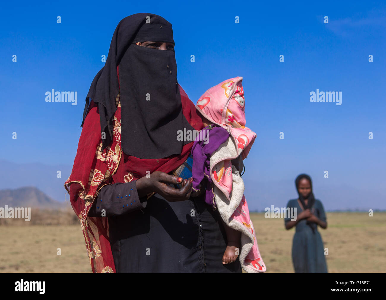 Ethiopian oromo mother with her baby dressed in burqa, Amhara region ...