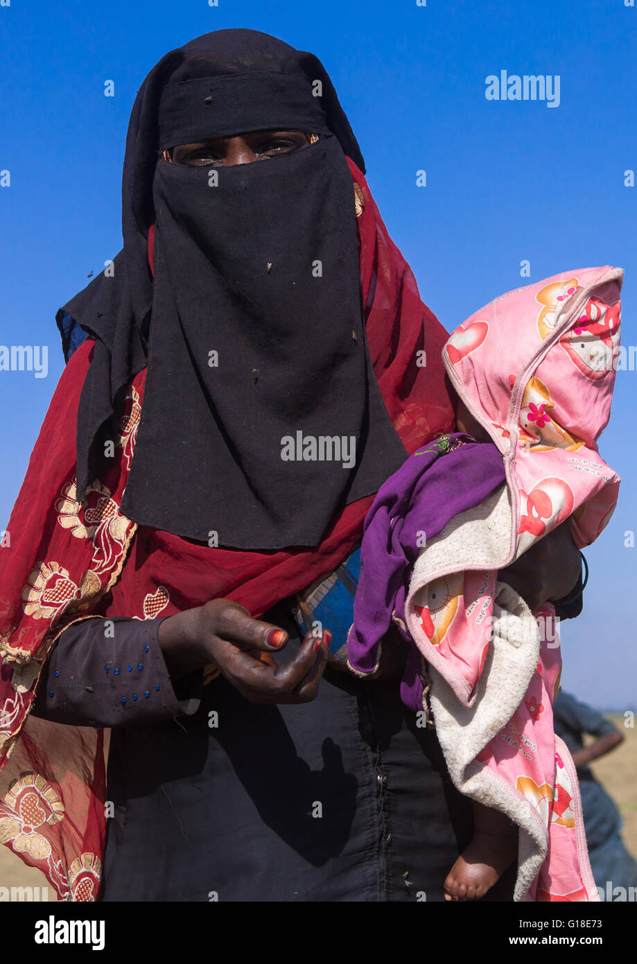 Ethiopian oromo mother with her baby dressed in burqa, Amhara region ...