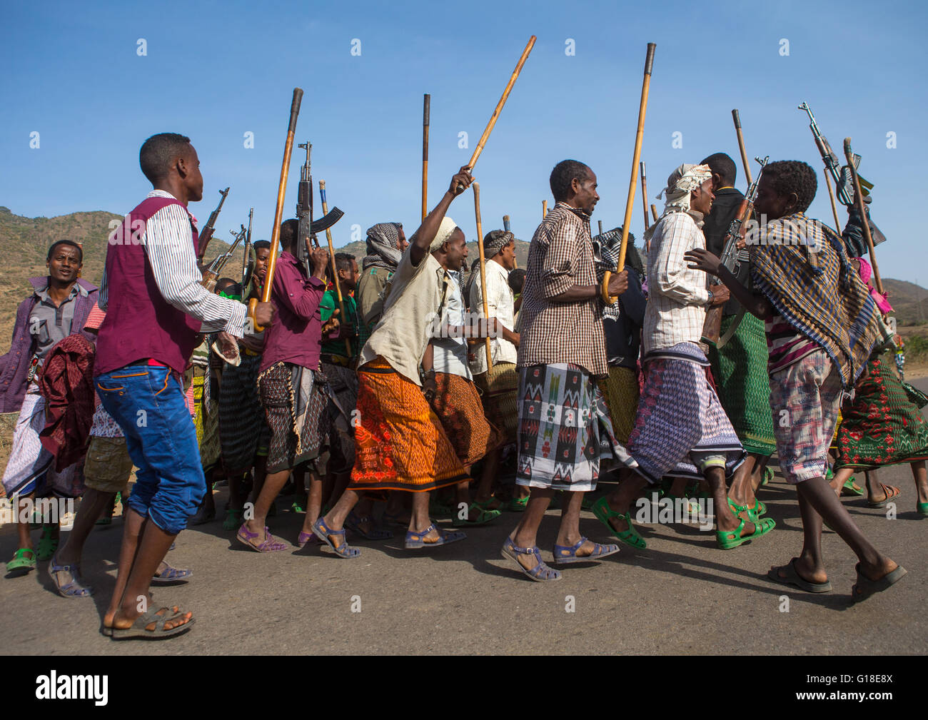 Oromo men with canes and kalashnikovs dancing during a wedding ...