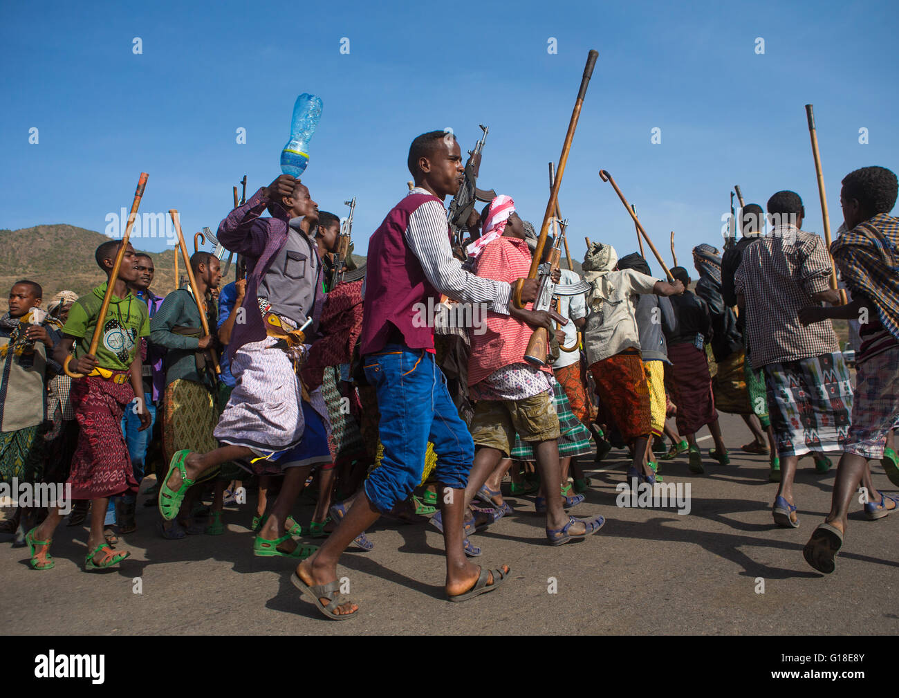 Oromo men with canes and kalashnikovs dancing during a wedding ...