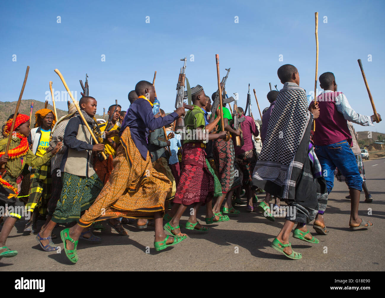 Oromo men with canes and kalashnikovs dancing during a wedding ...