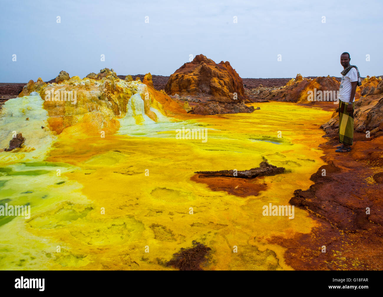 Afar man in front of colorful volcanic landscape in the danakil ...