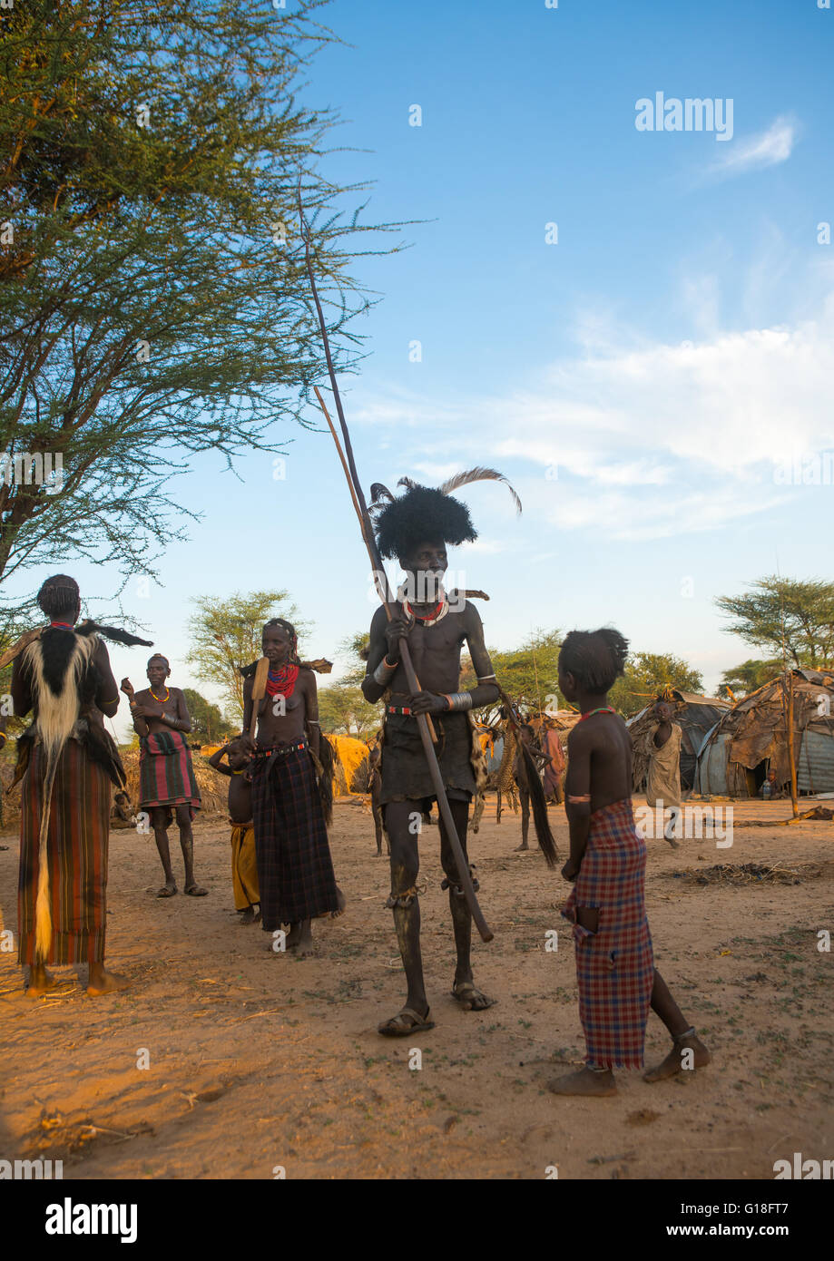 Dassanech men put on leopard skins and ostrich feathers headdresses to ...