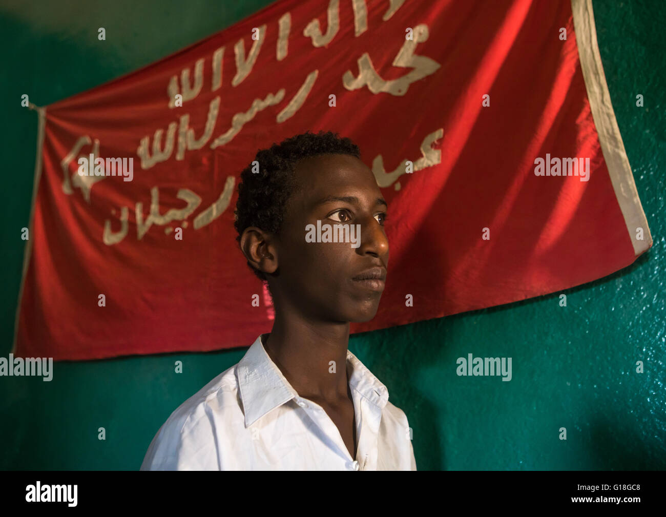 Sufi man worshipper in front of islamic red flag, Harari region, Harar ...