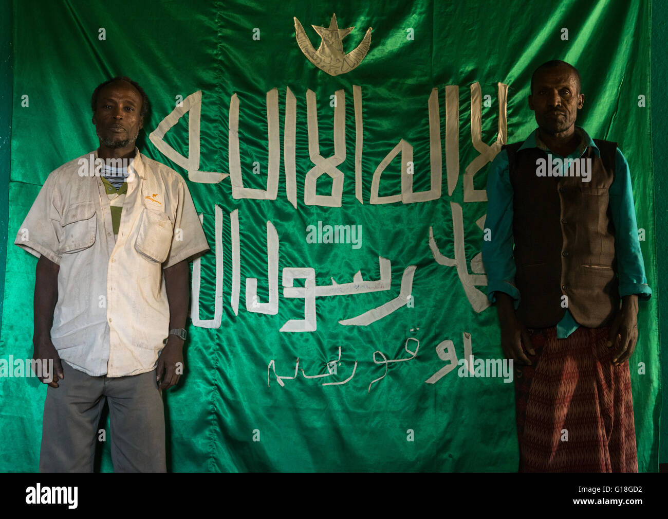 Sufi men worshippers in front of islamic flag, Harari region, Harar ...