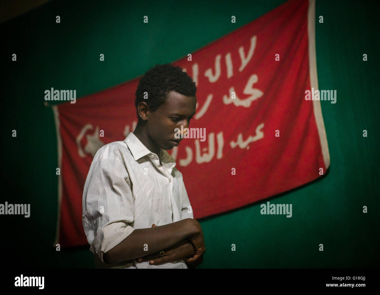 Sufi man worshipper in front of islamic red flag, Harari region, Harar ...