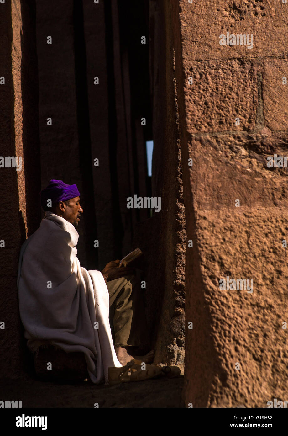 Lonely ethiopian orthodox man praying with a bible, Amhara region ...