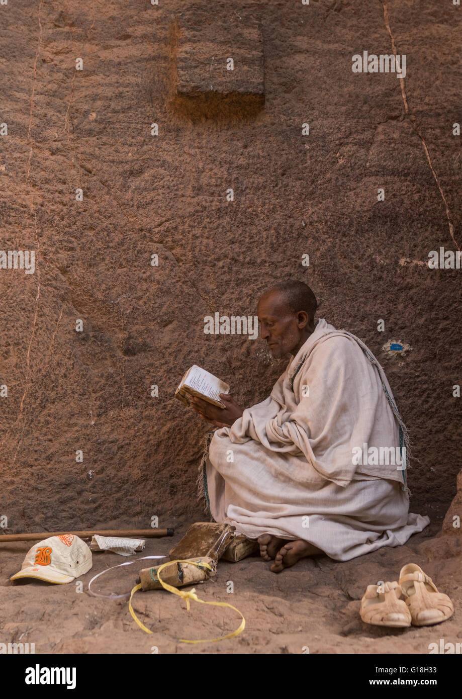 Lonely ethiopian orthodox man praying with a bible, Amhara region ...